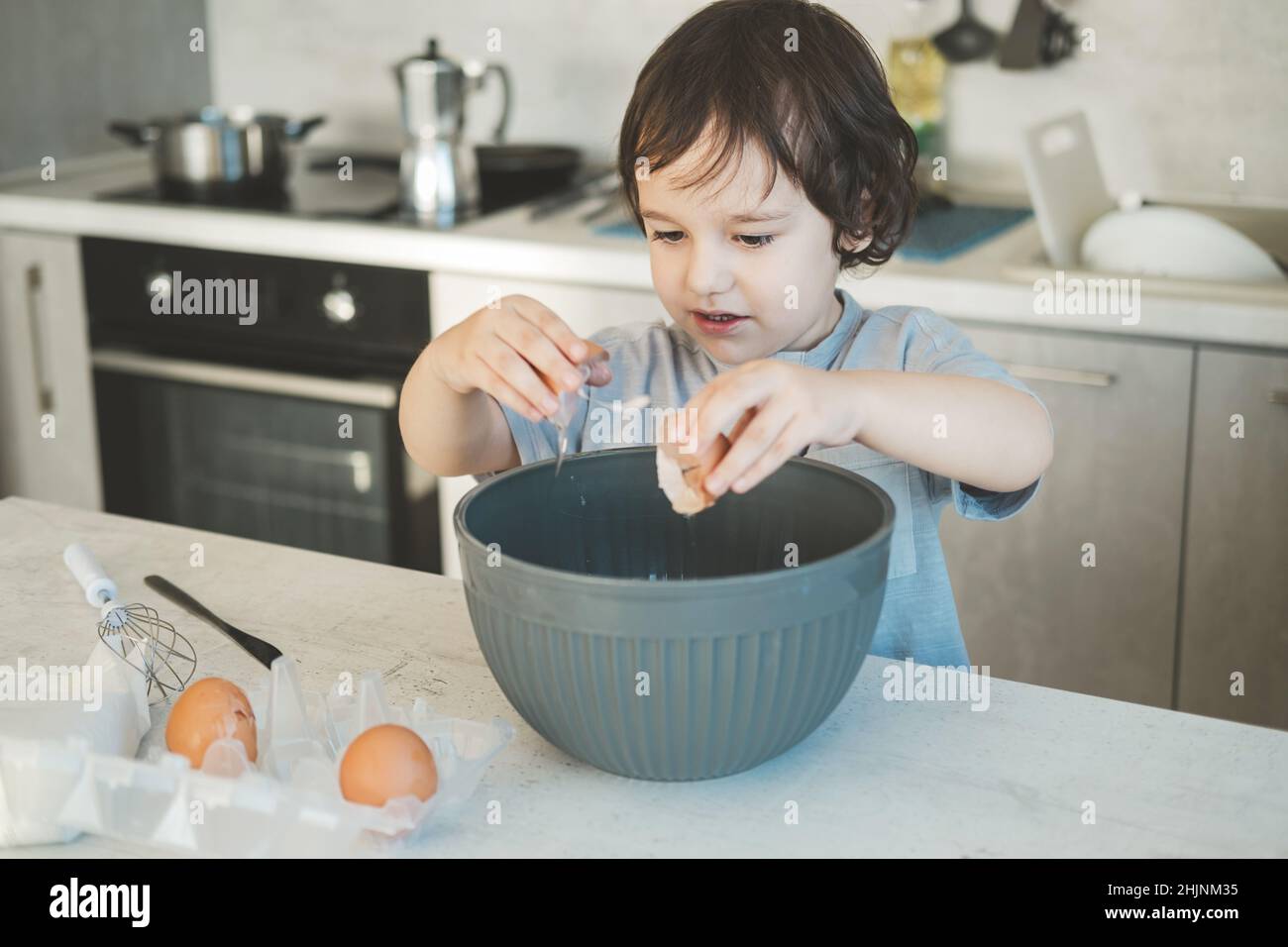 A little boy is cooking in the kitchen Stock Photo - Alamy