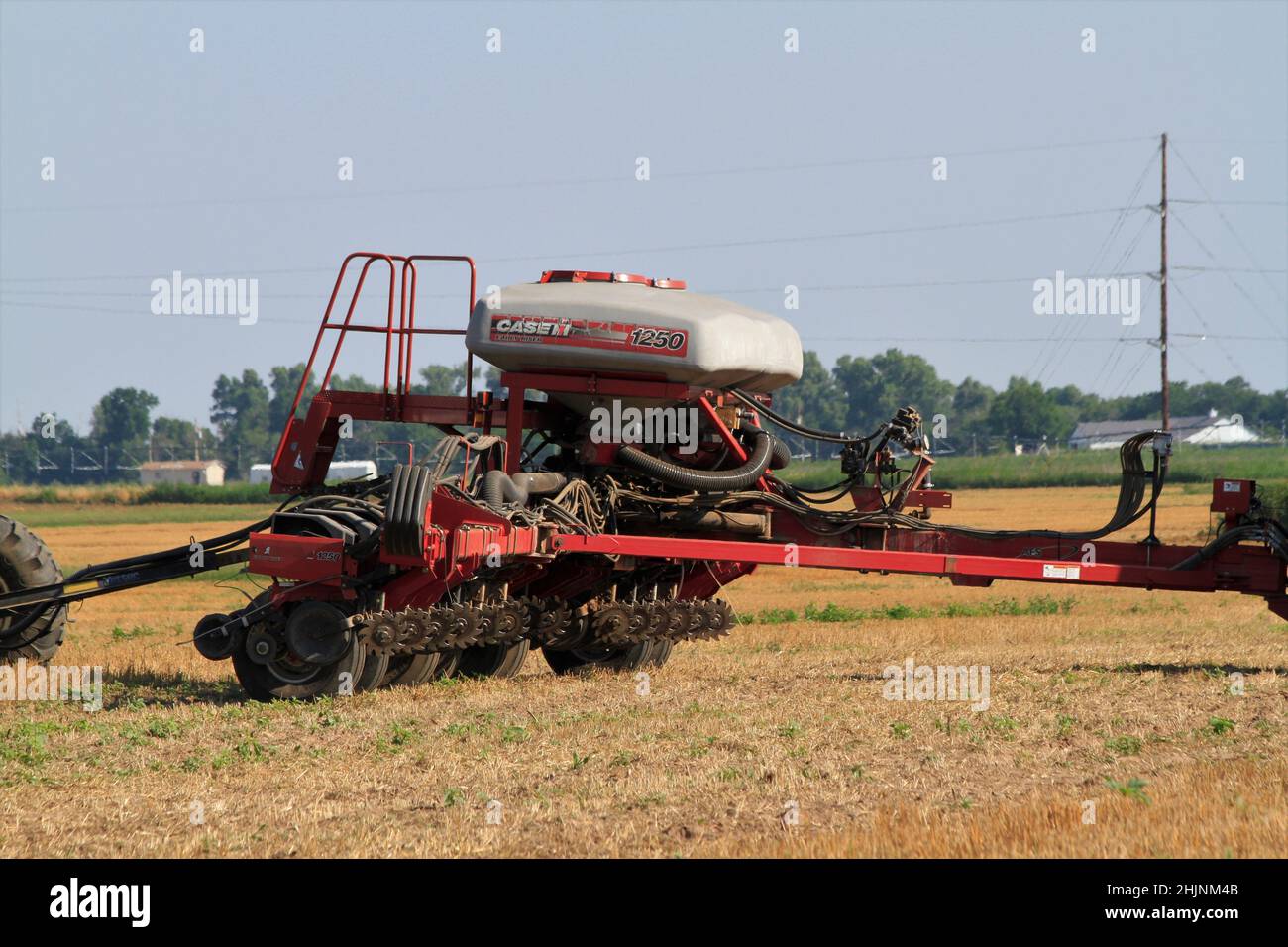 A Case International farm tractor in a farm field with spray equipment ...