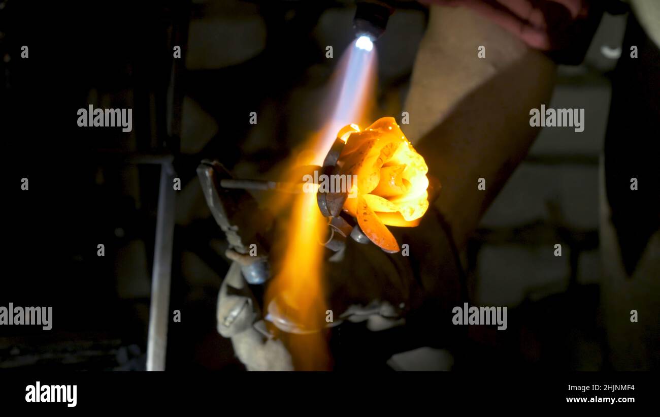 Blacksmith aligns leaves of iron rose and makes the final shape of the flower. Blacksmith makes ...