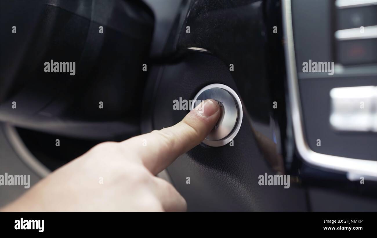 Driver hand pushes engine start stop button. Stock. Modern luxury ... Driver hand pushes engine start stop button. Stock. Modern luxury ...