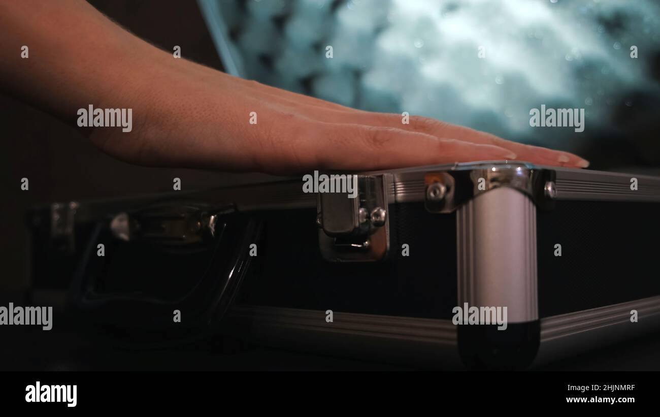 Close up of female hand opening metal briefcase. Woman opening the ...