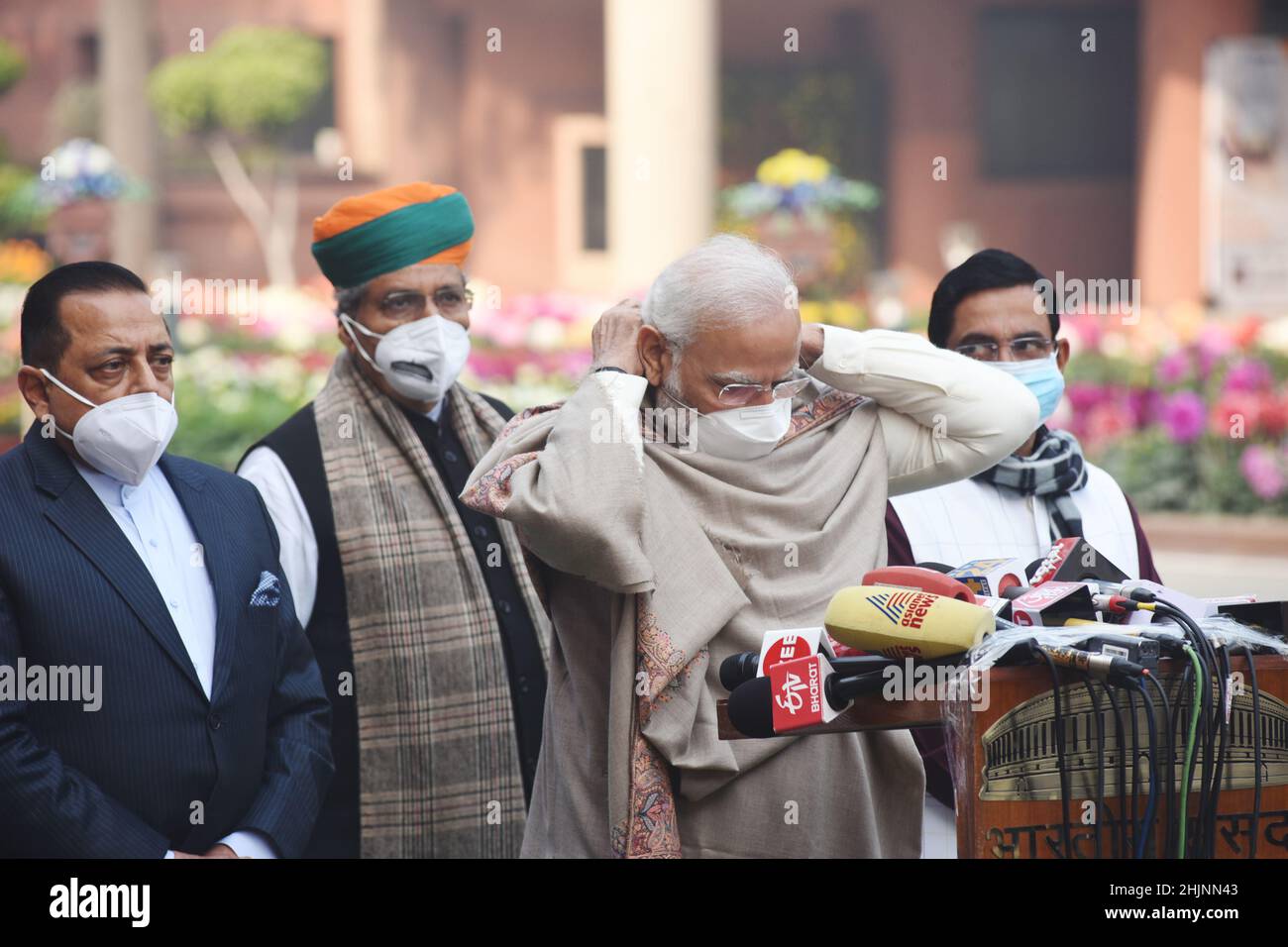 Prime Minister Narendra Modi takes his mask off before he addreses ...