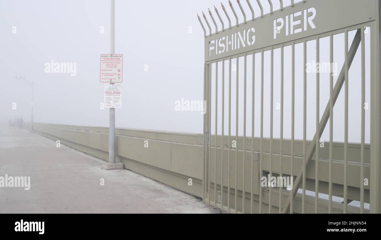 Metal gate on Ocean Beach pier in fog, misty California coast, USA ...