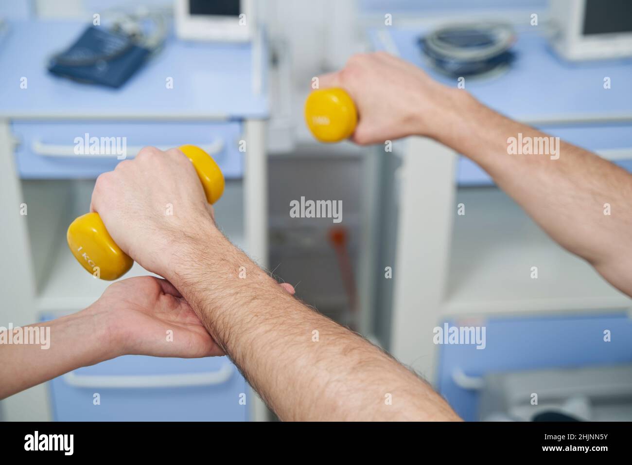 Adult Caucasian male patient performing supported arm exercise Stock ...