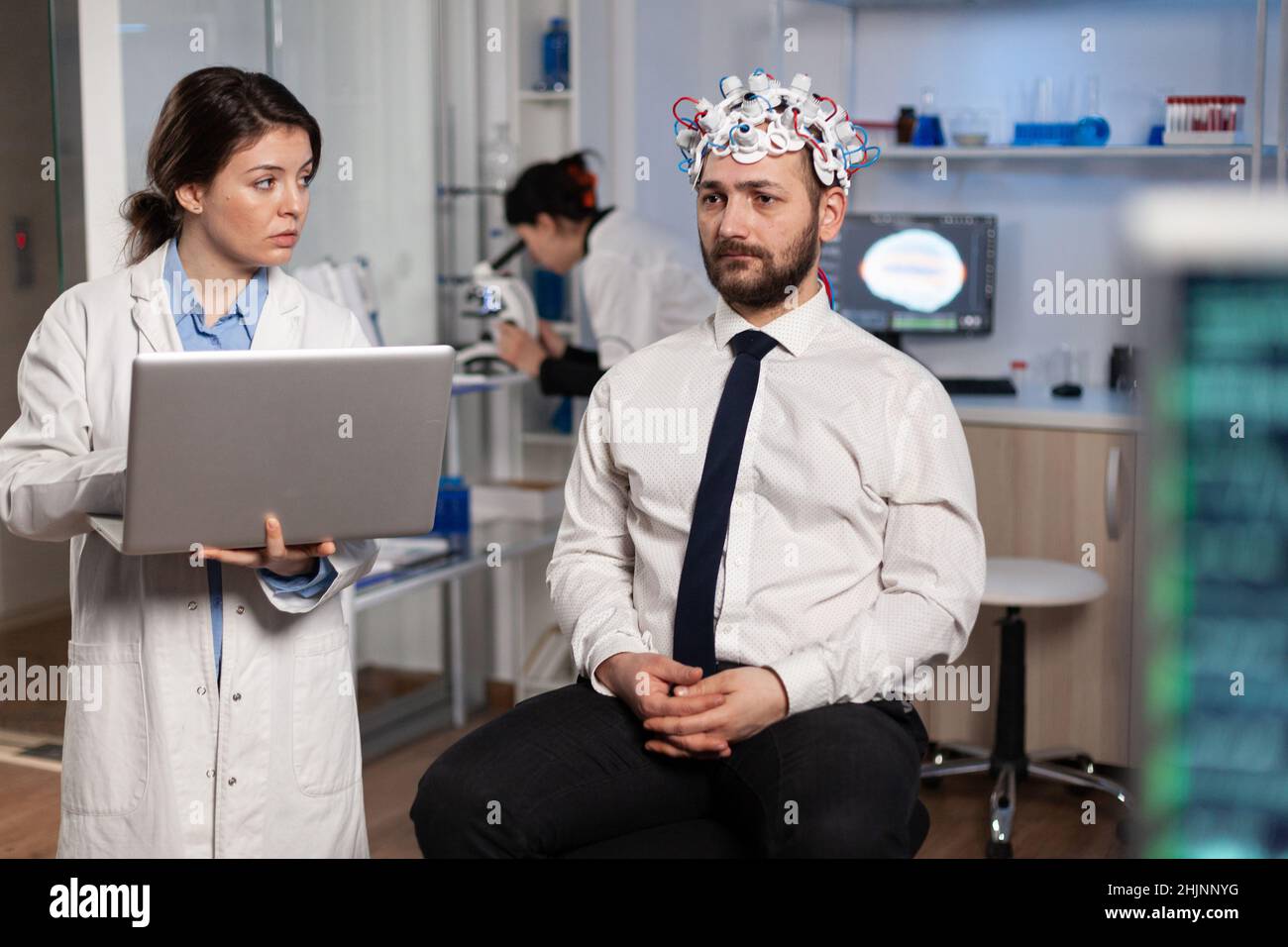 Researcher woman doctor typing neurological disease symptoms on laptop ...