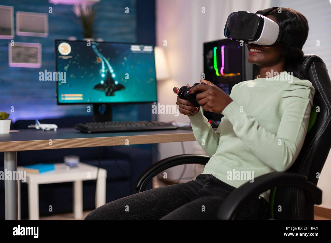 Focused african american cyber gamer holding gaming controller playing ...