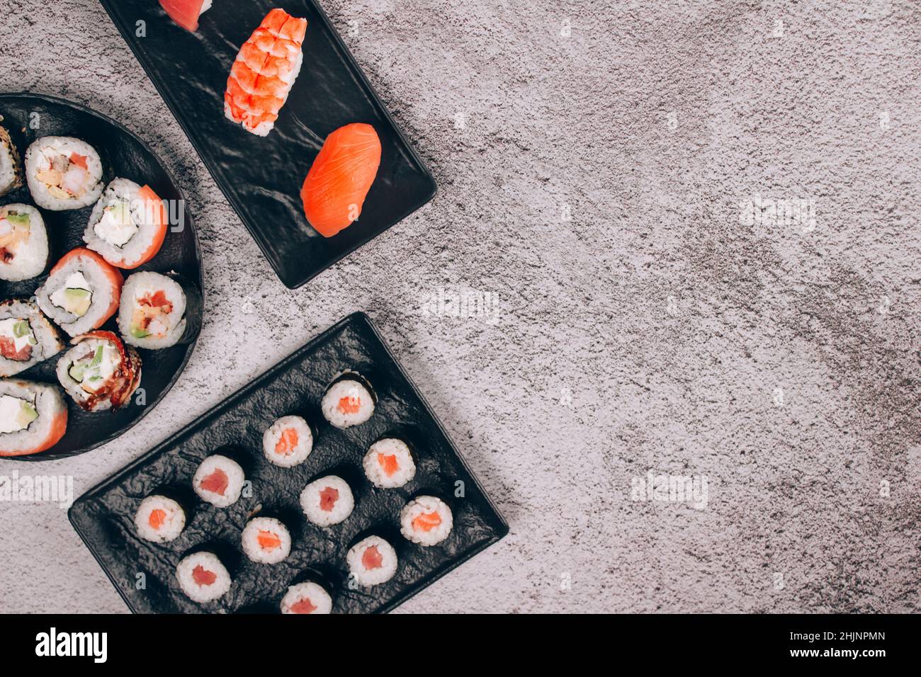 Top view on sushi bar lunch menu - different sushi rolls with salmon ...