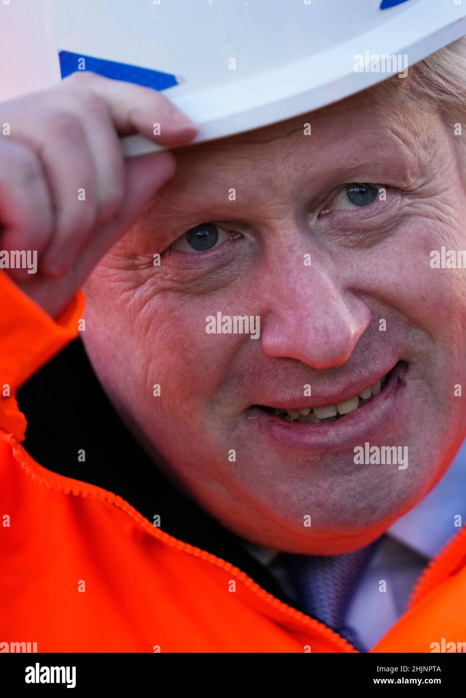 Prime Minister Boris Johnson tips his hat at the end of an interview ...