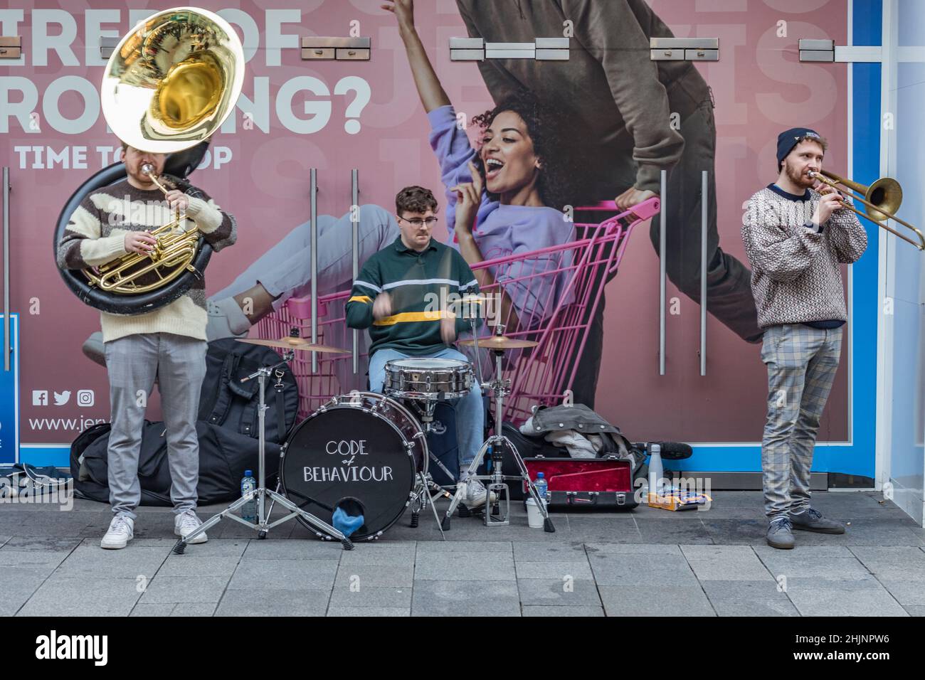 Pedestrians listening, watching, taking photo street musicians, buskers ...