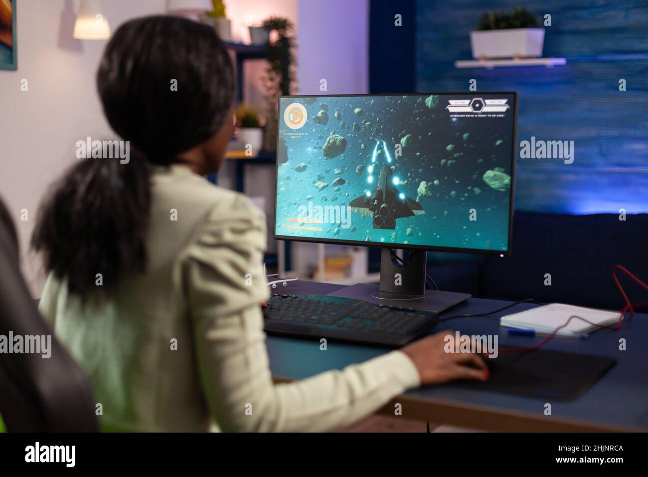 African american pro gamer woman sitting at desk in gaming home studio ...