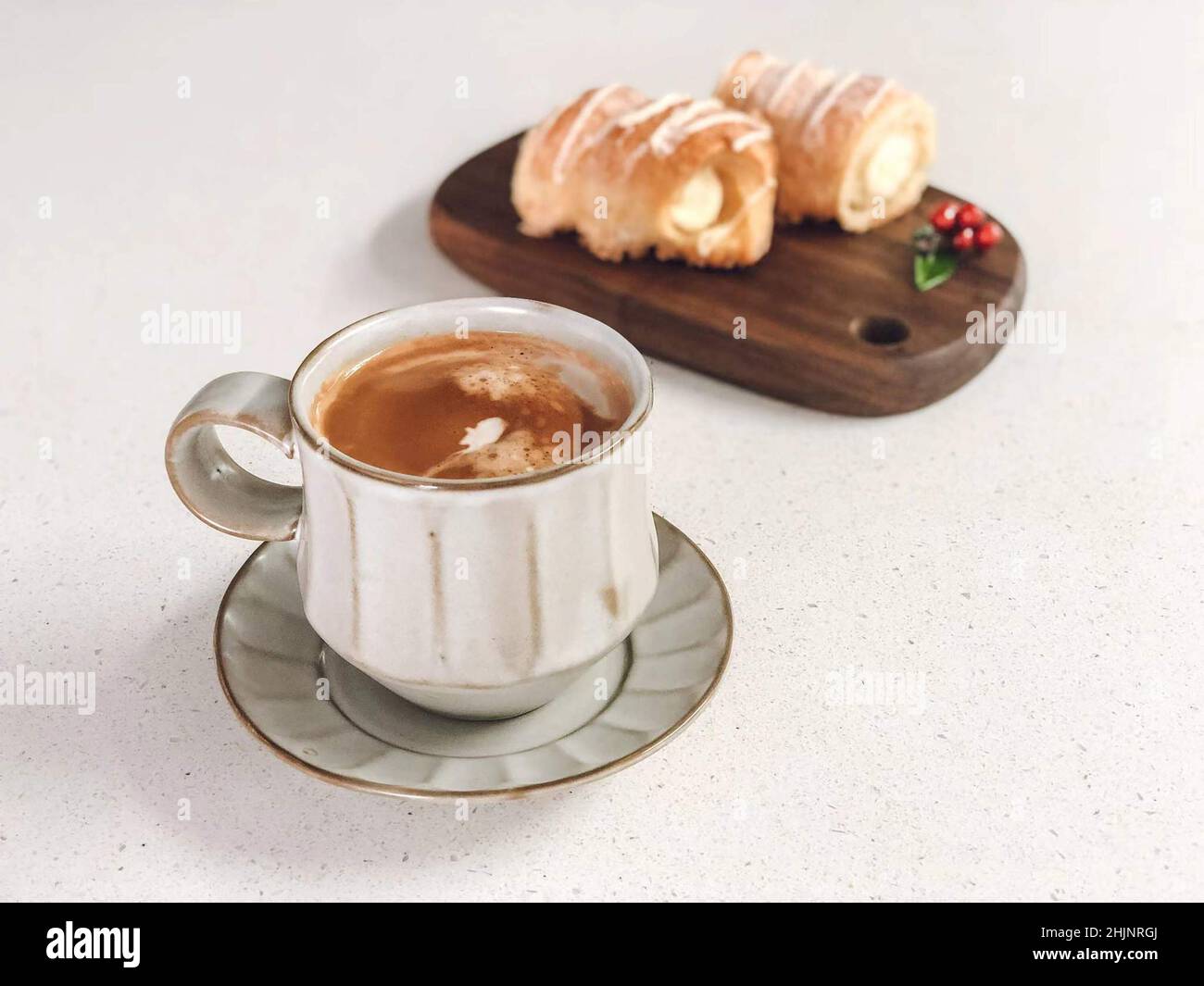Cup of coffee with bread rolls on a white table Stock Photo - Alamy