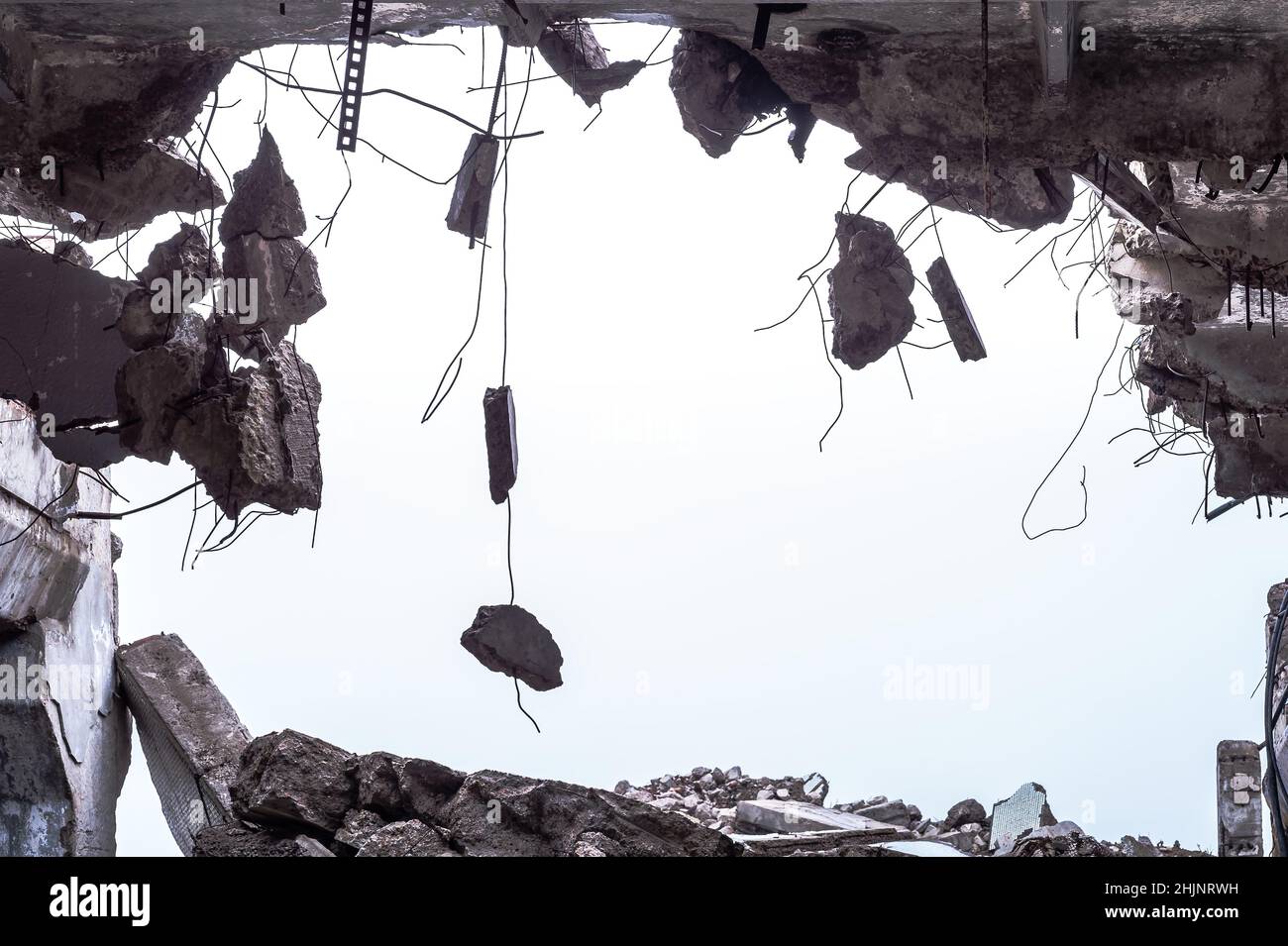 A hole in the body of a building with a pile of construction debris and ...