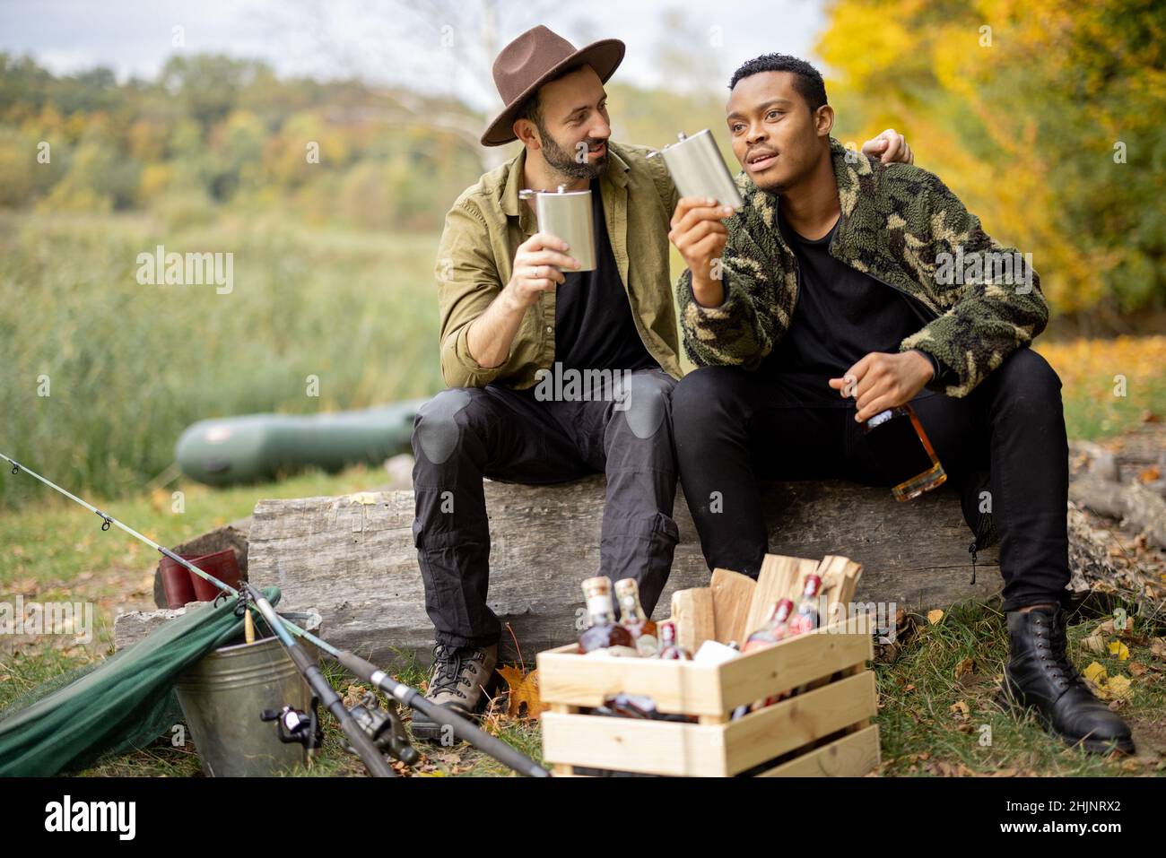 Men with alcohol on fishing outdoors Stock Photo - Alamy
