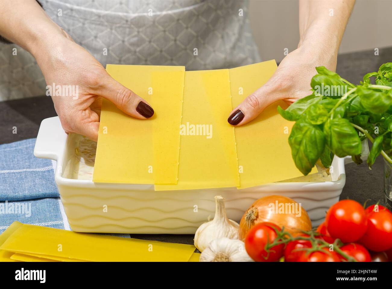 Woman preparing meat lasagna in kitchen. lasagna recipe - Italian food ...