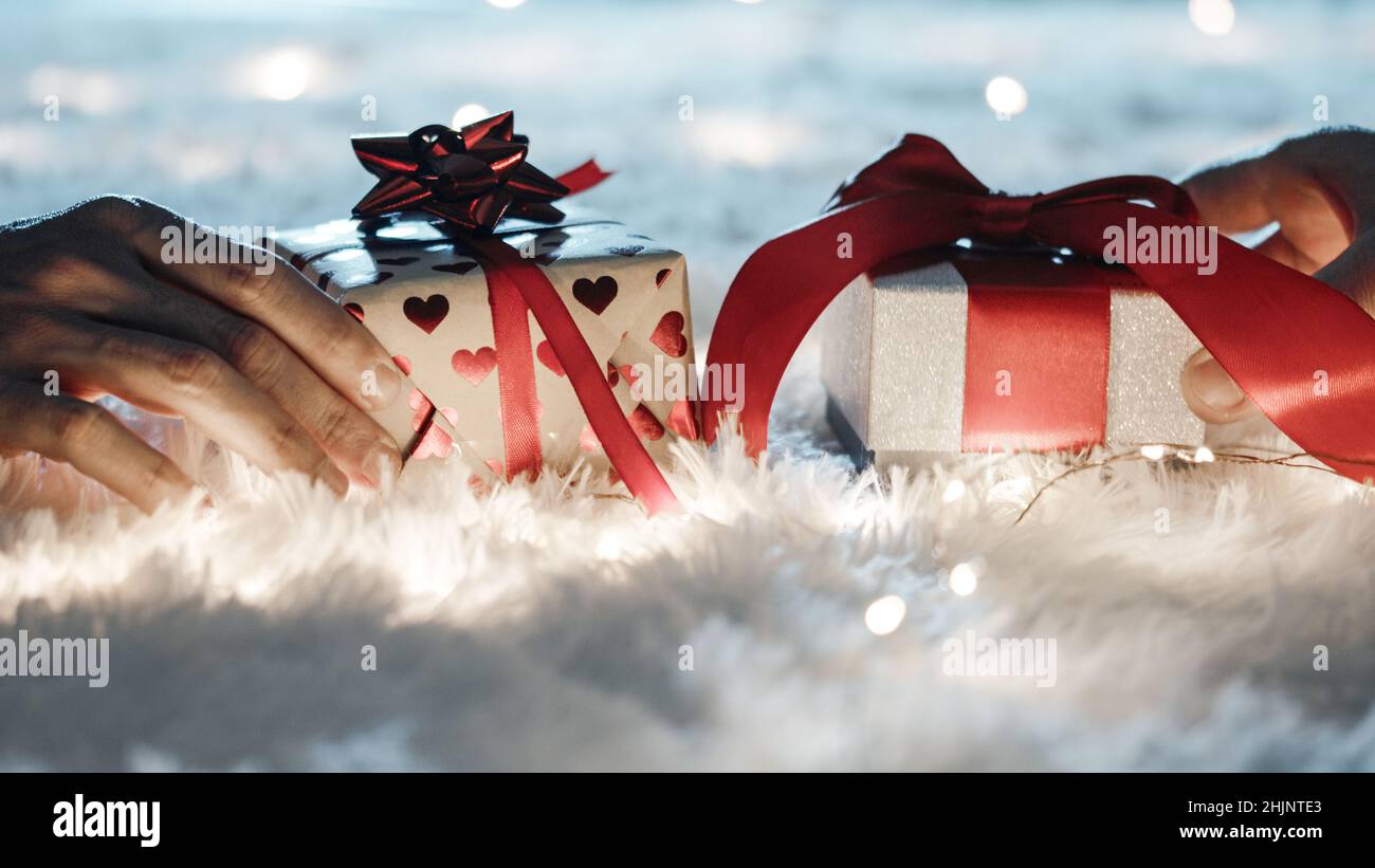 couple hands exchange gifts for Valentine's Day Stock Photo - Alamy