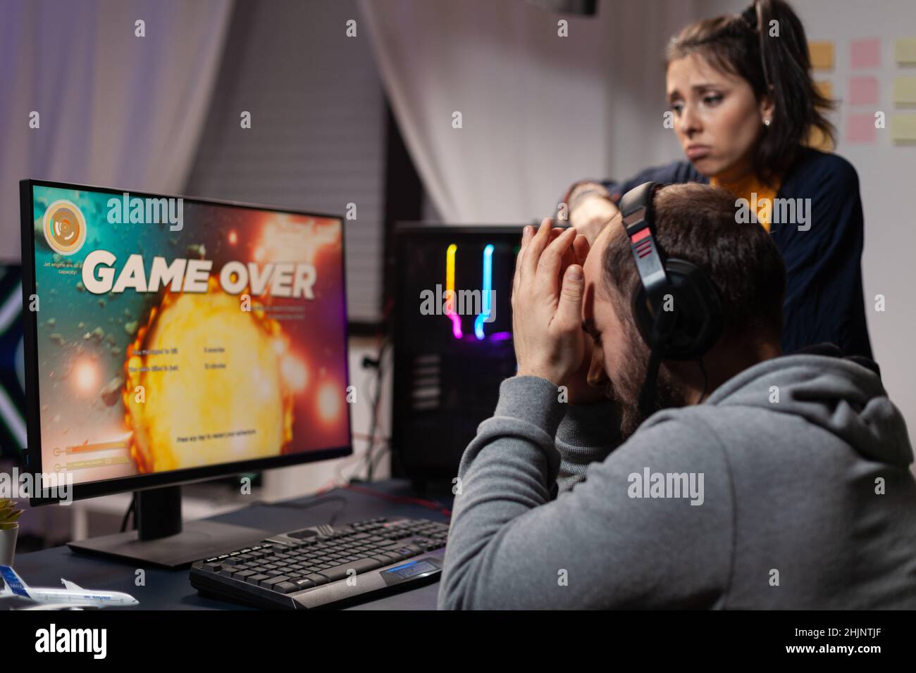 Couple of gamers feeling sad about losing video games in front of ...