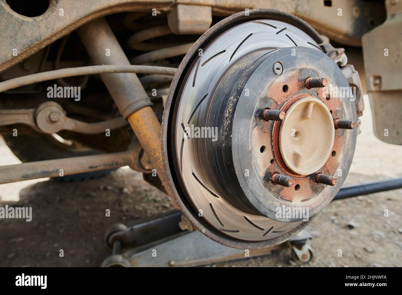 Closeup old, worn out and rusty car brake system. Rear disc brake of a ...