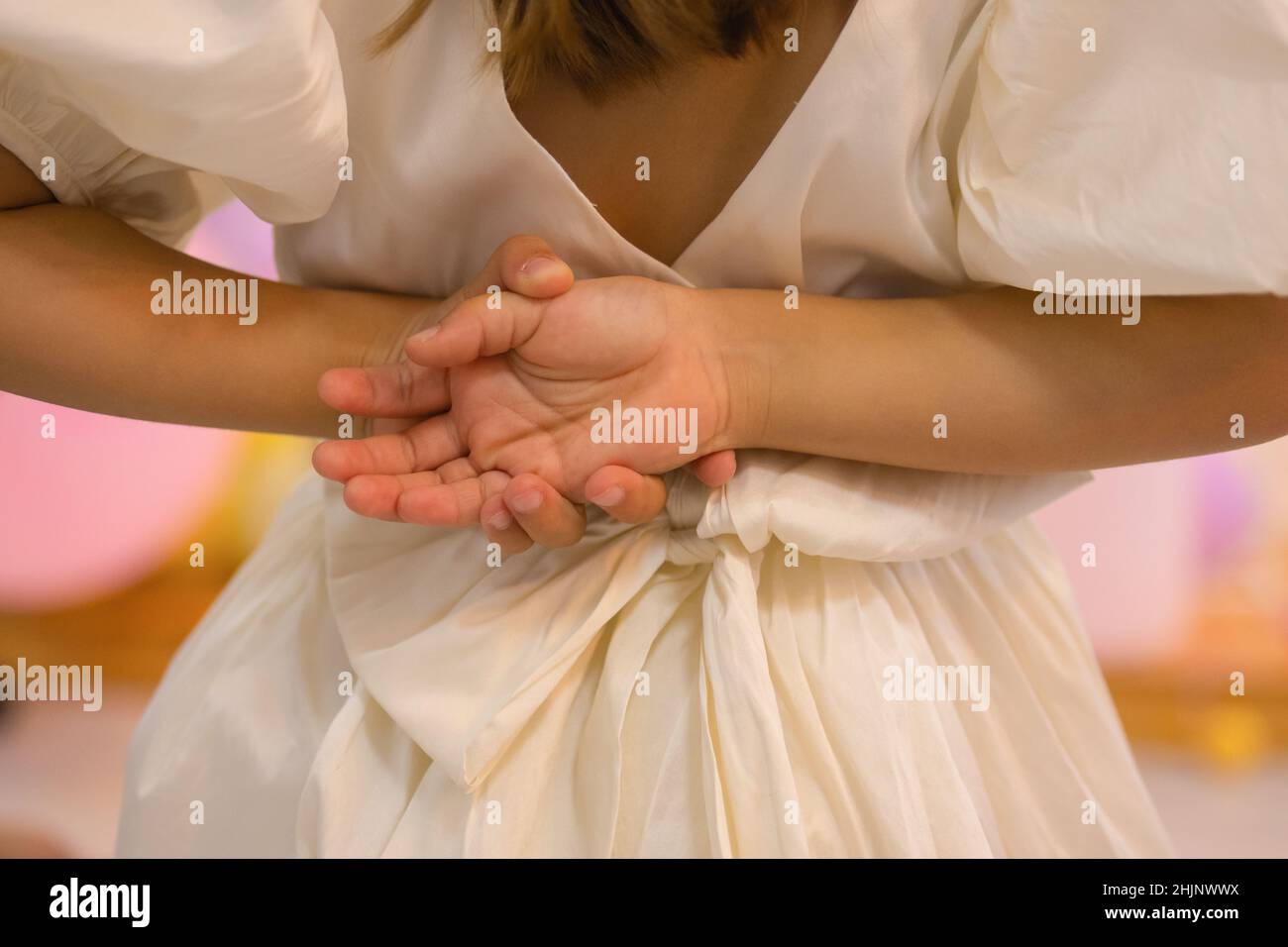 The girl behind her back holds a hand with crossed fingers Stock Photo ...