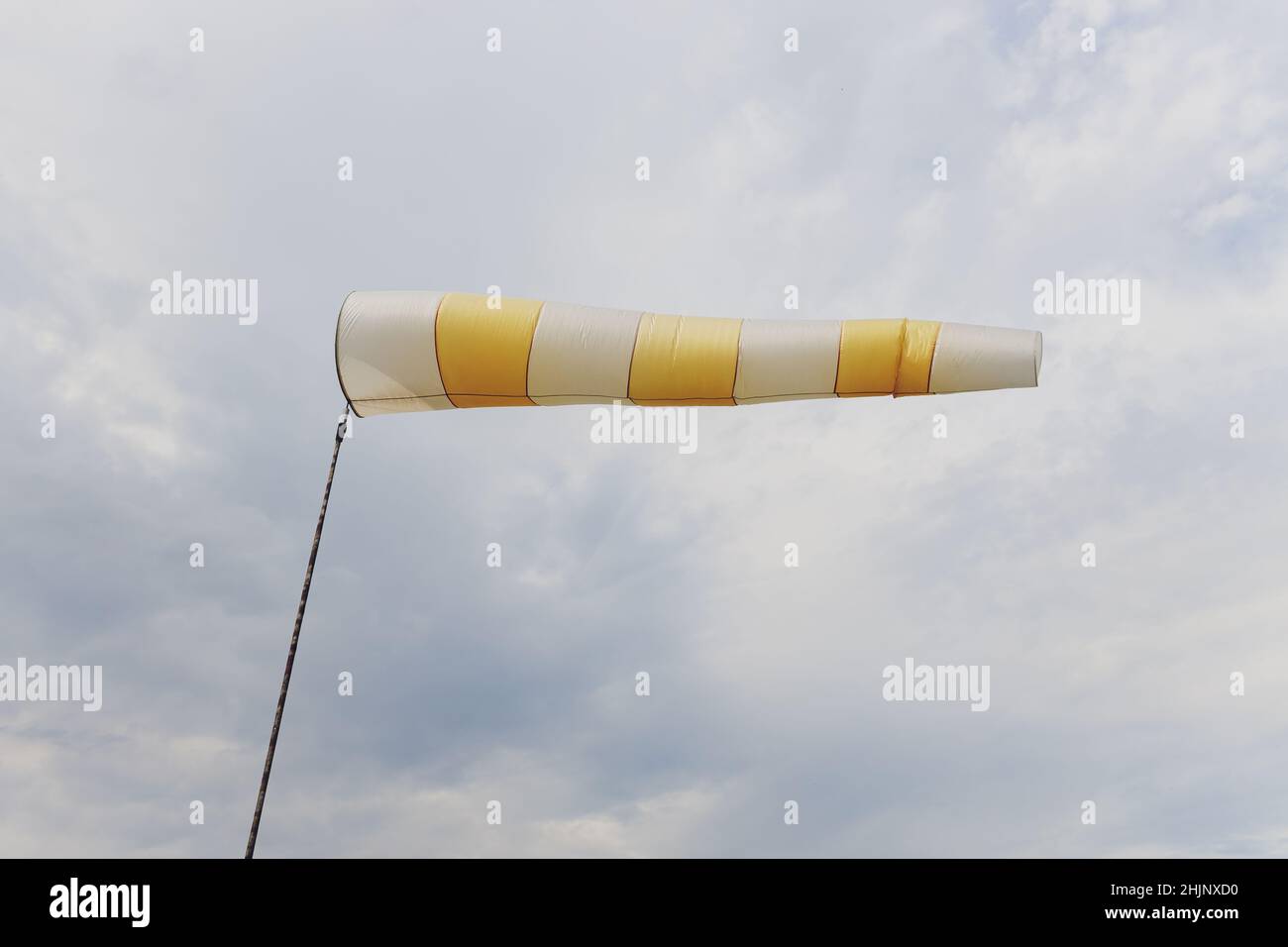Windsock indicator of wind on runway airport Stock Photo - Alamy