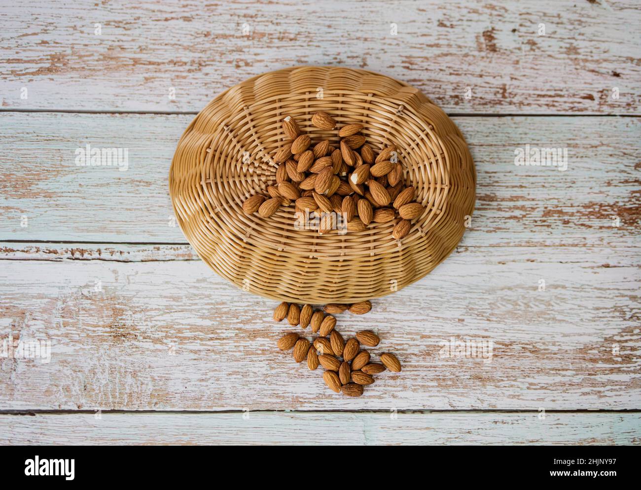 healthy food - a handful of almonds on a wicker basket. vegetarian food ...