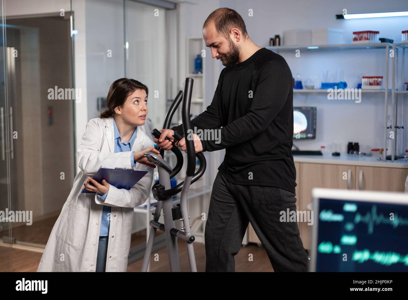 Specialist physician doctor talking with sportman in gym training ...