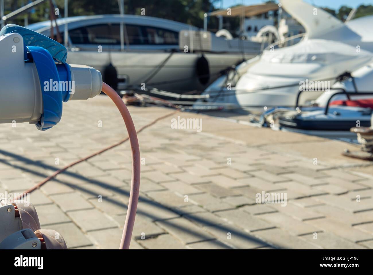 Close-up of a plug plugged into a yacht in the marina of Portopetro ...