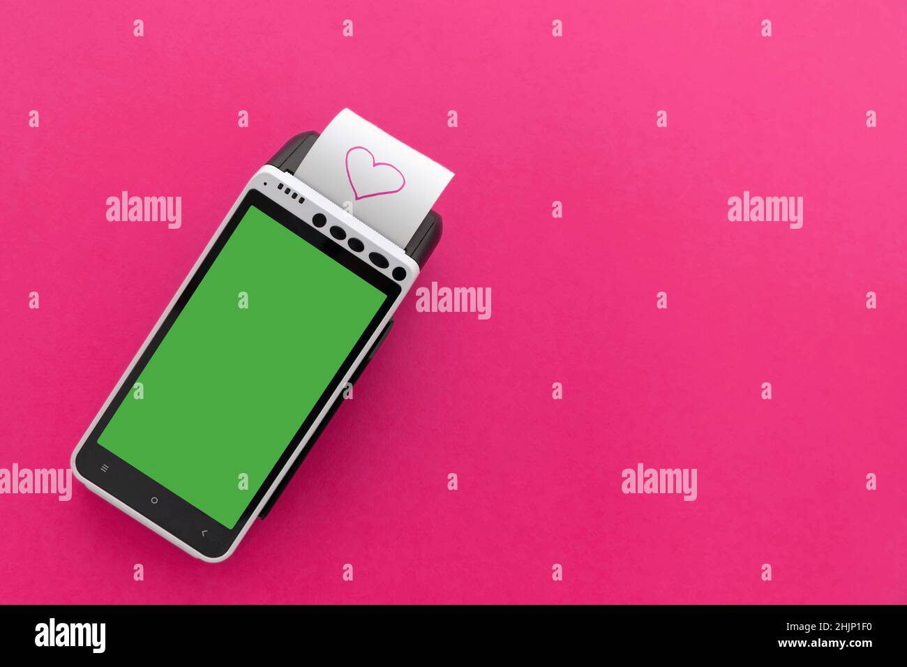Credit card POS terminal with printed reciept with a pink heart picture ...