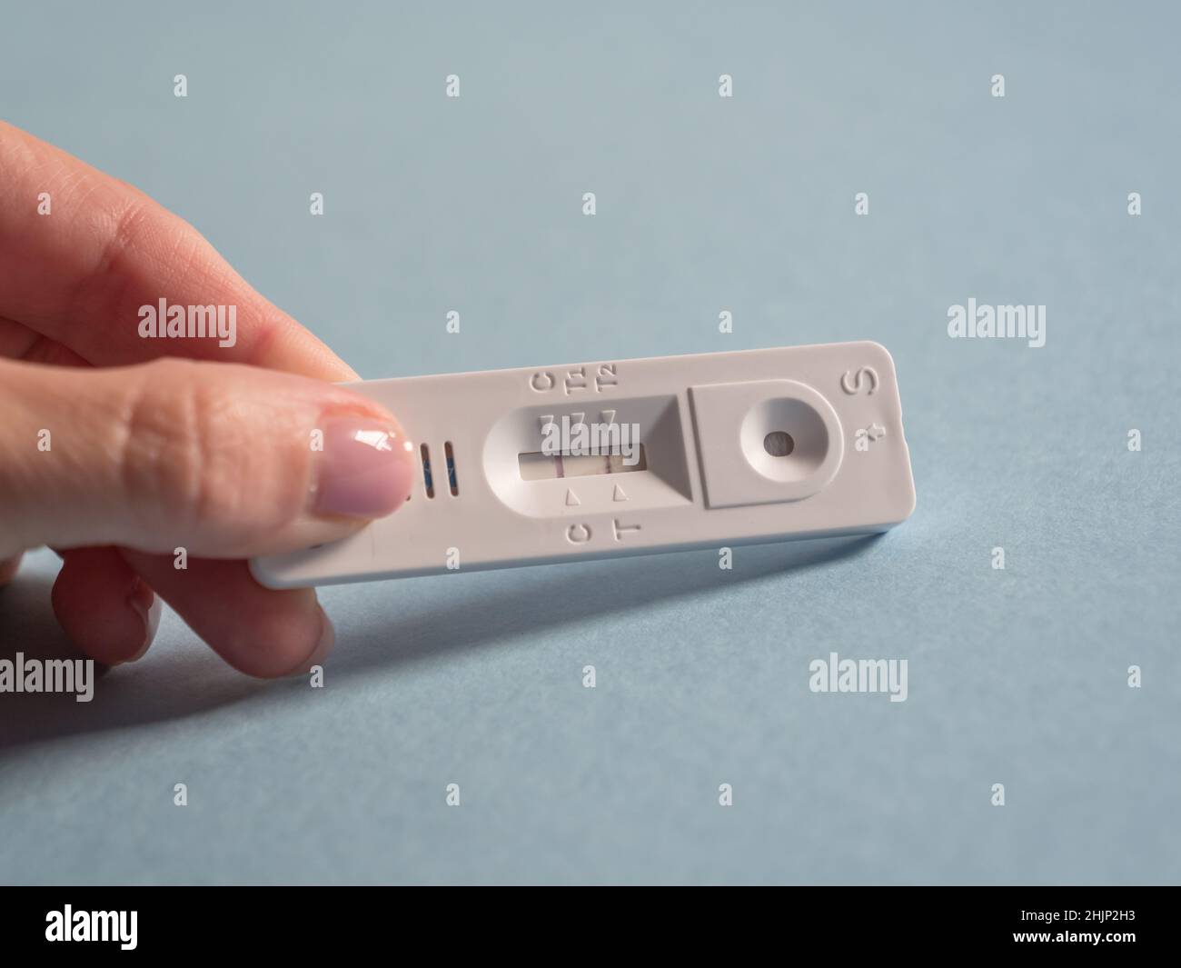 positive rapid antigen test. Positive SARS-COV-2. woman hands holds ...