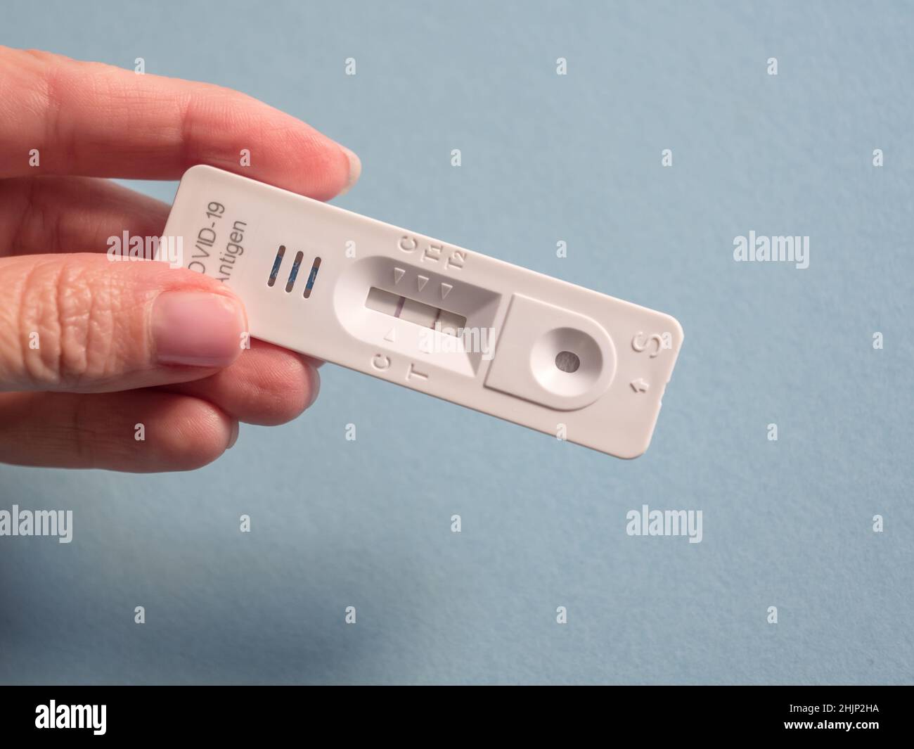 positive rapid antigen test. Positive SARS-COV-2. woman hands holds ...