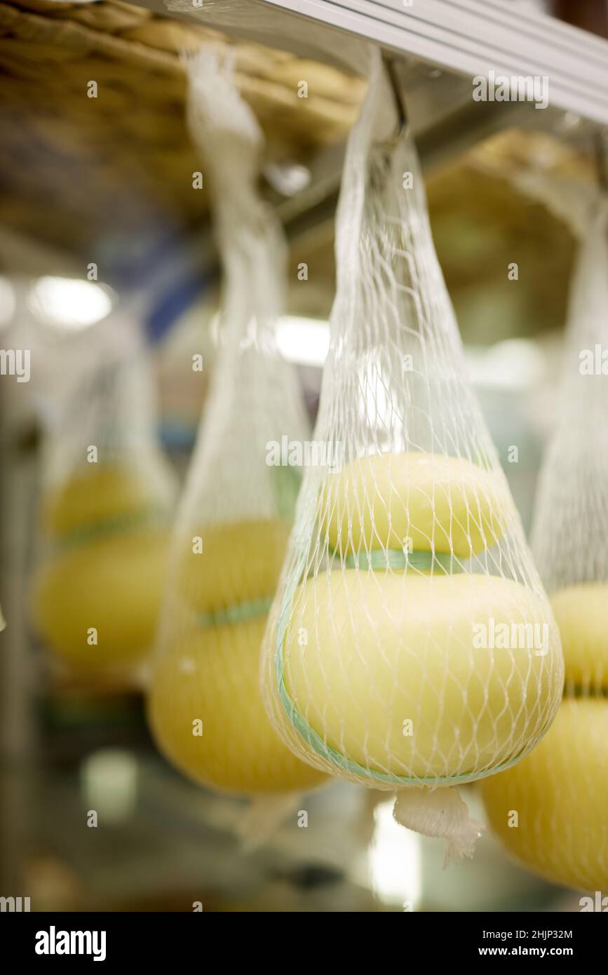 Delicious fresh Caciocavallo and Scamorza cheese hanging. Italian ...