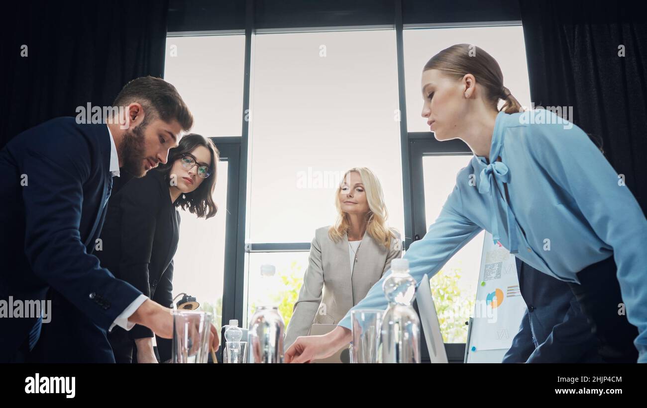low angle view of multiethnic business colleague standing in meeting ...