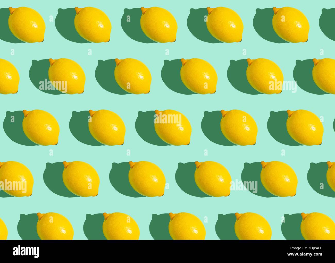 Yellow whole lemons on minimal blue background on bright sun light with ...