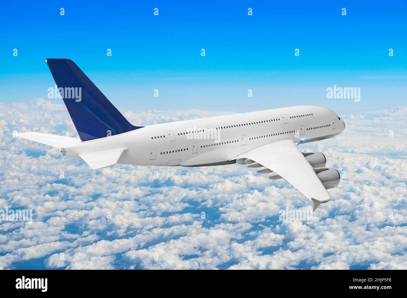 Passenger huge liner airplane fly above clouds and blue sky Stock Photo ...