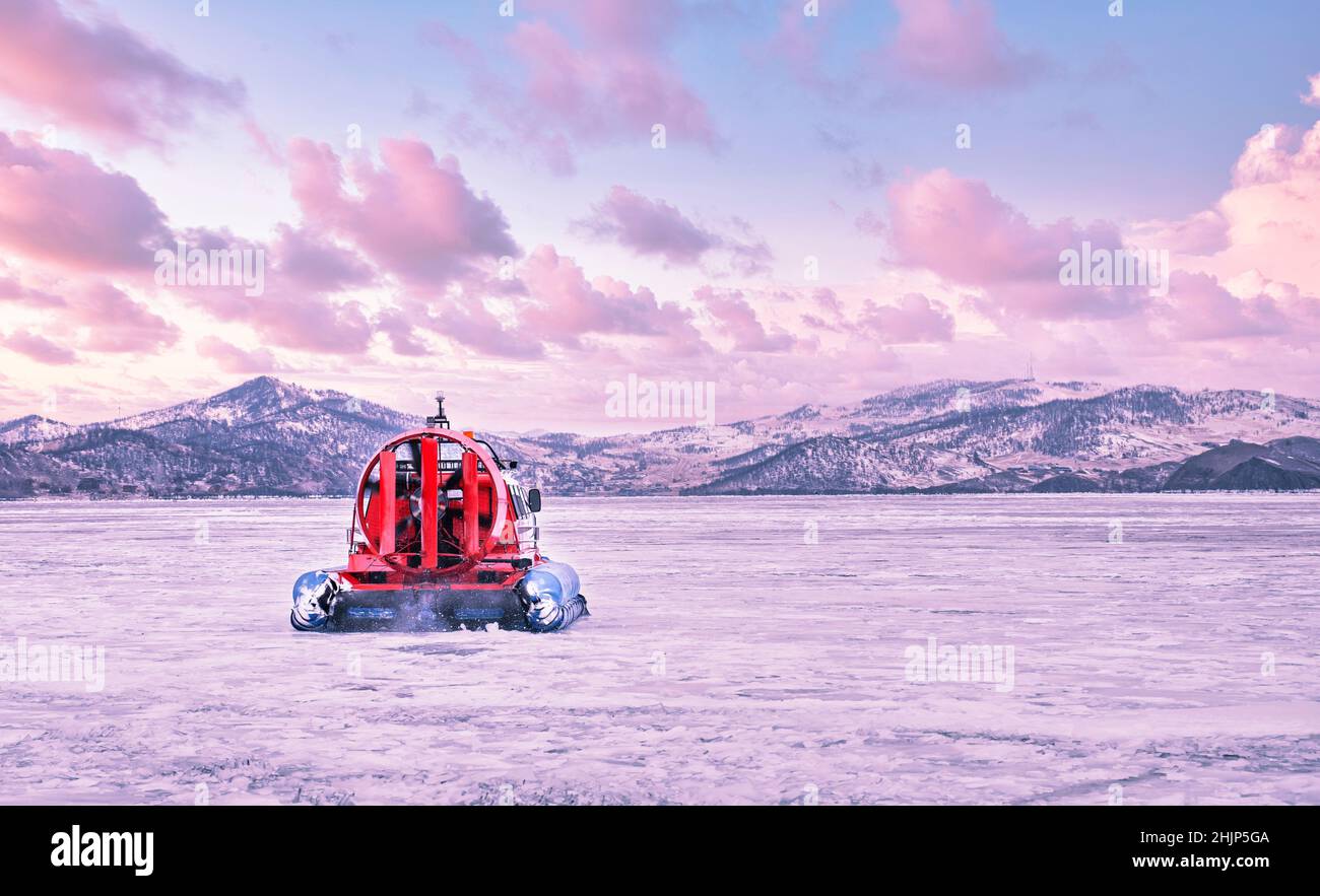 Hovercraft quickly glides over the surface of the transparent frozen ...