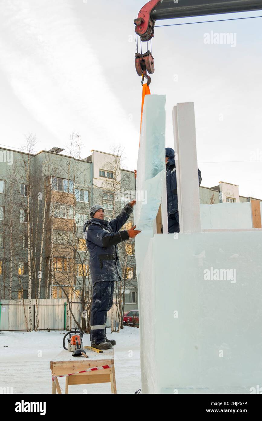 Installers adjust and install another ice block to the overall ...