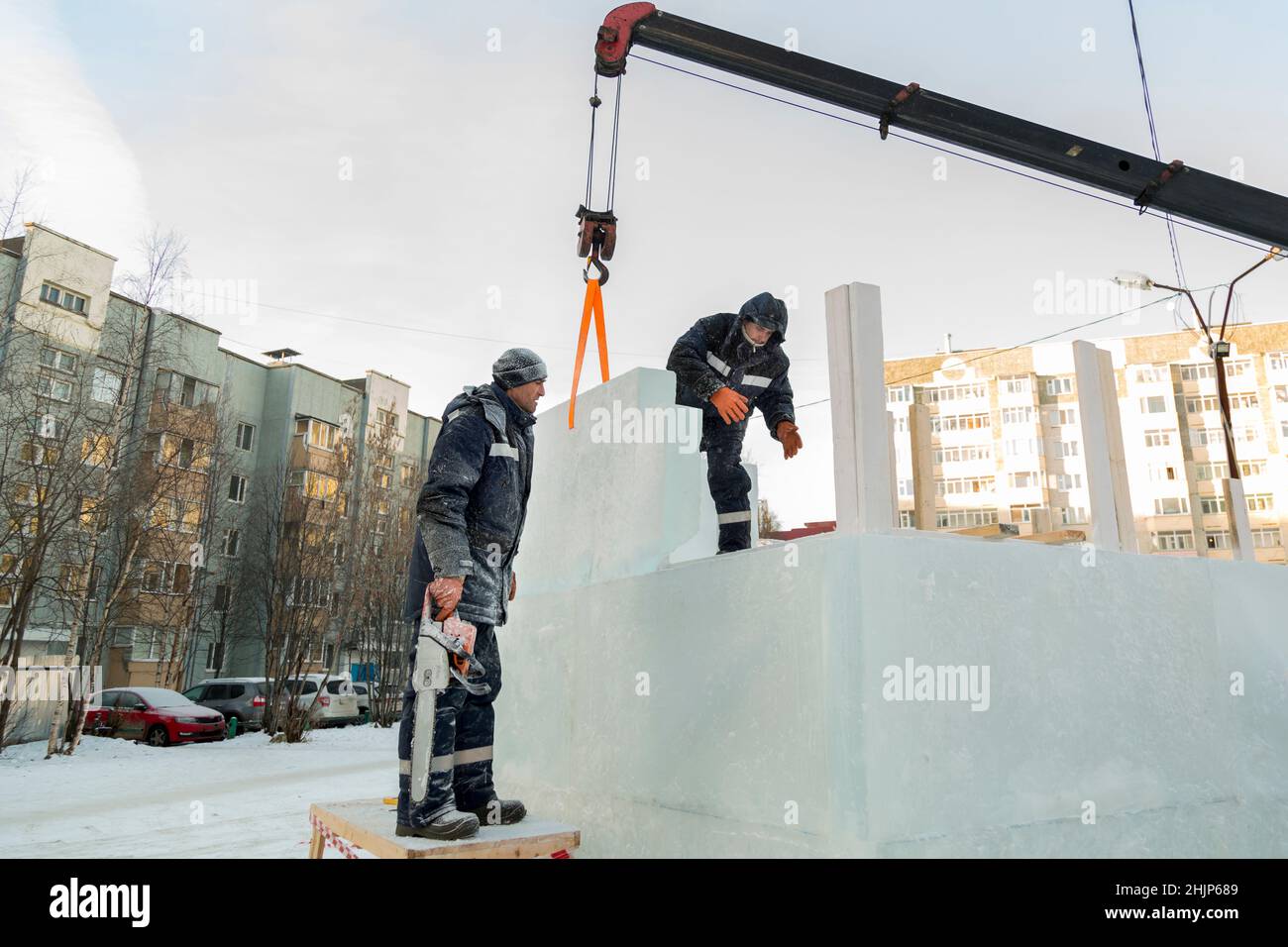 Installers adjust and install another ice block to the overall ...