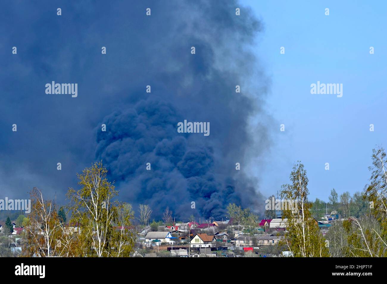 Smoke from a fire on the outskirts of the city in the private sector Stock Photo - Alamy