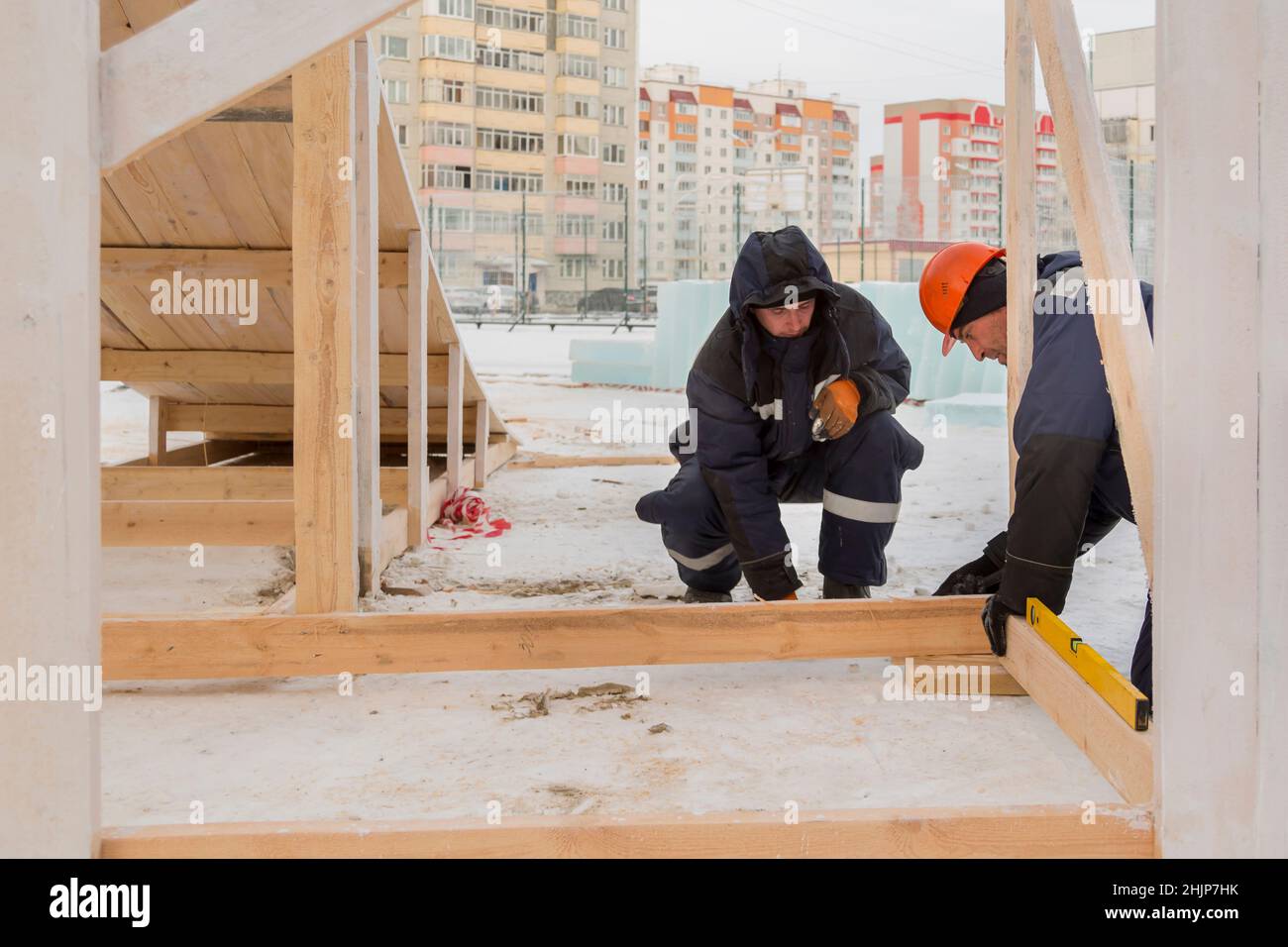 Workers level the wooden beam of the frame of a wooden slide Stock ...