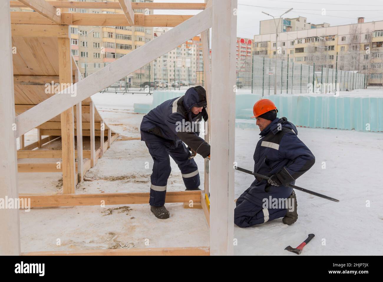 Workers level the wooden beam of the frame of a wooden slide Stock ...