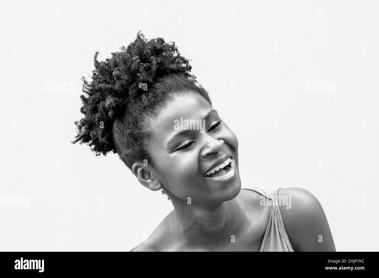 Portrait of a beautiful black colombian model laughing in black and ...