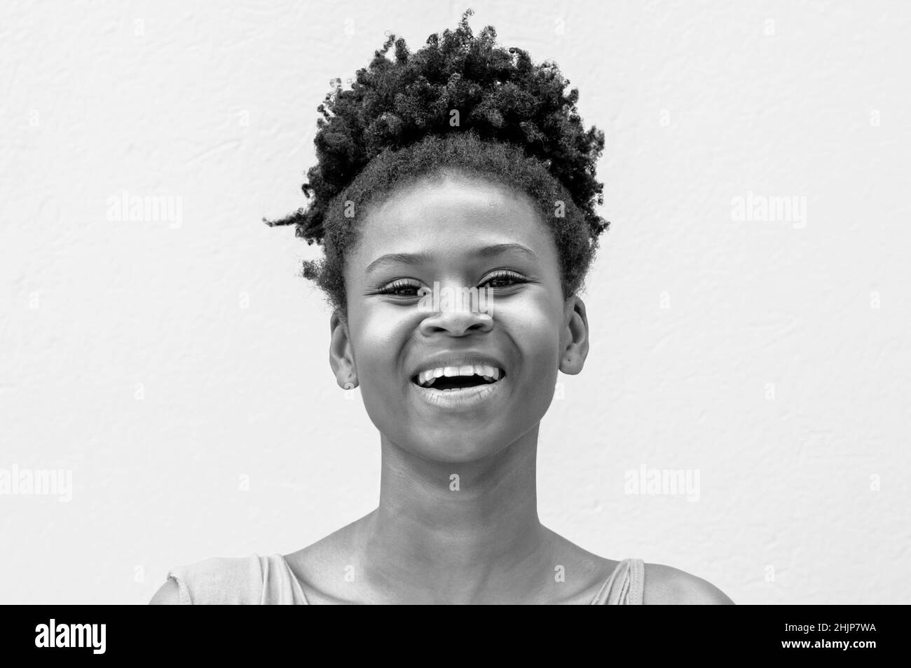 Portrait of a beautiful black colombian model laughing in black and ...