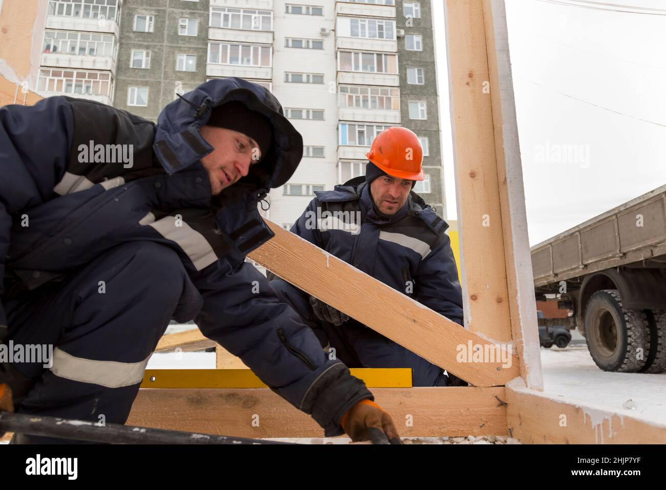 Workers level the wooden beam of the frame of a wooden slide Stock ...