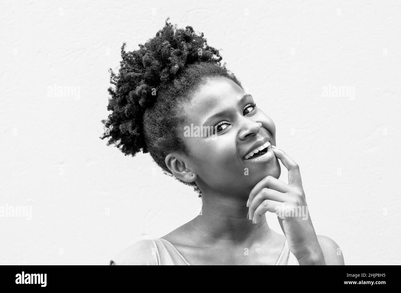 Portrait of a beautiful black colombian model laughing in black and ...