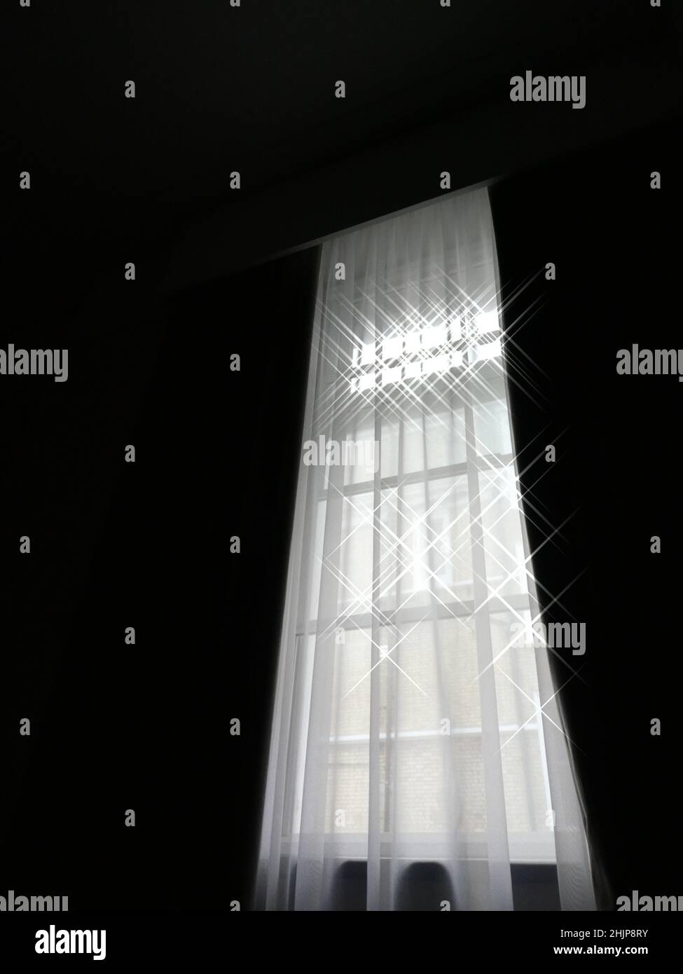 semi-abstract picture of long tall window with sunlight streaming in ...