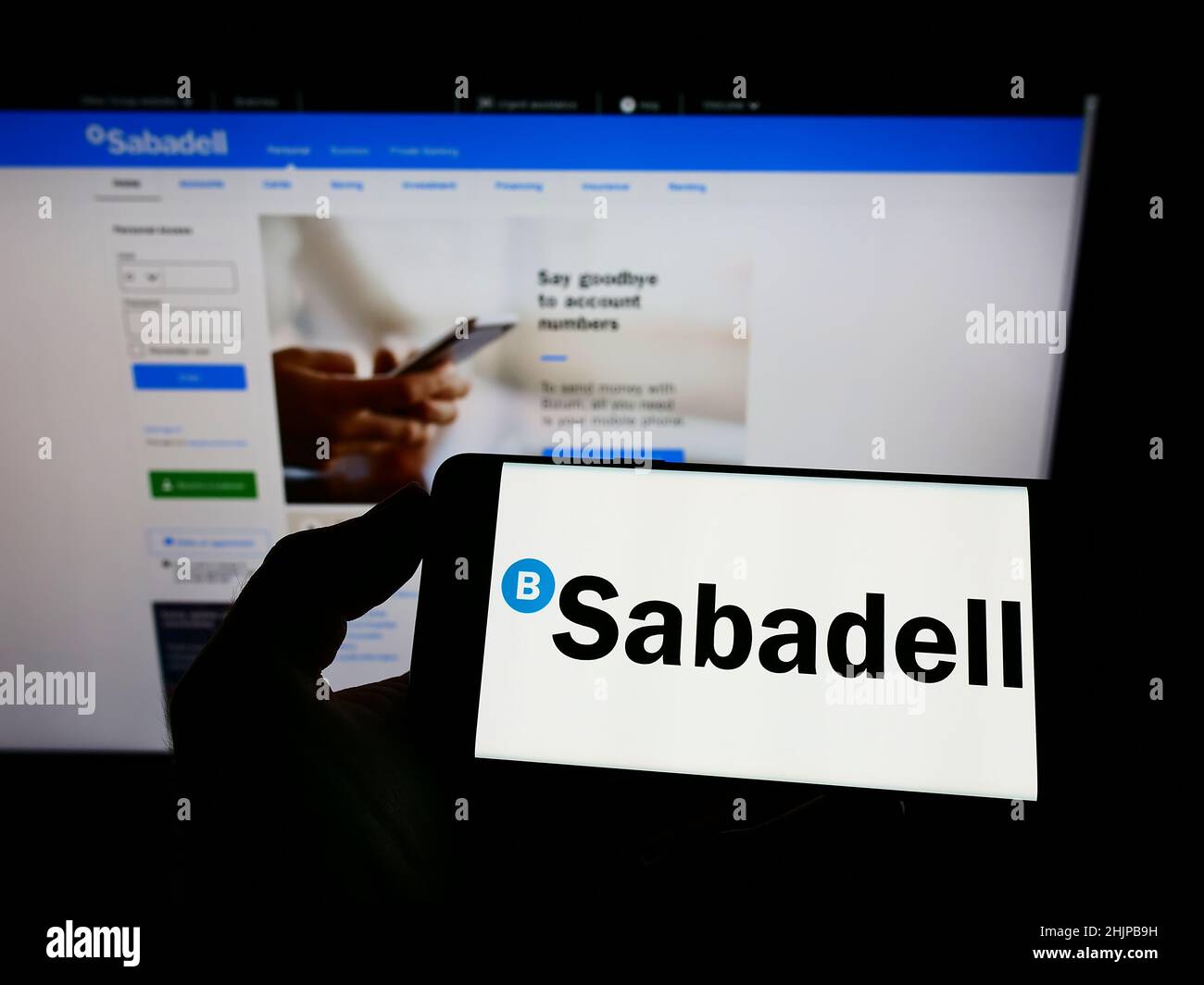 Person holding smartphone with logo of Spanish banking company Banco de ...