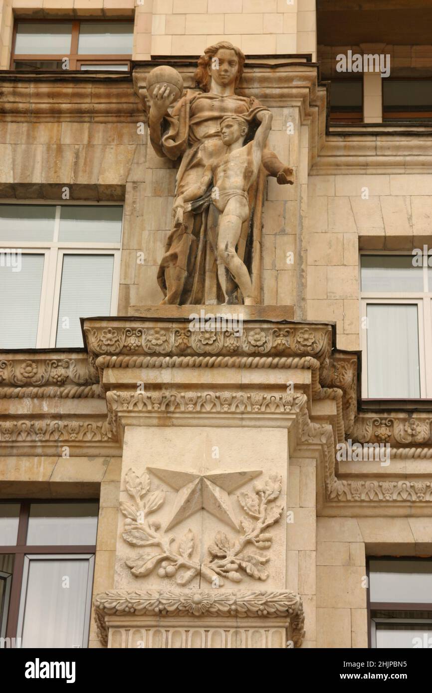 Mother and child sculpture. Detail of High-rise Stalinist building on ...