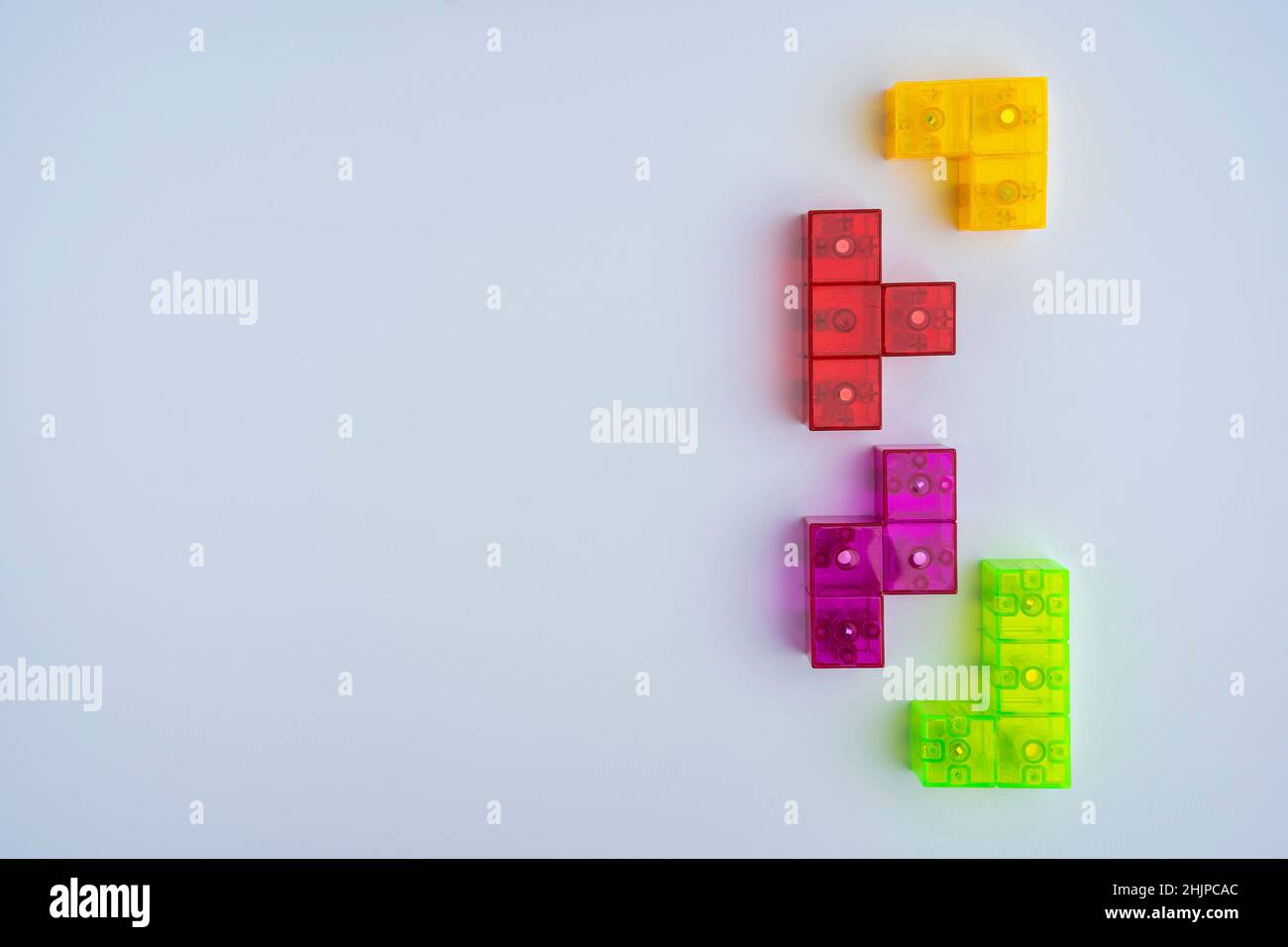 three-dimensional colored tetris figures on a white background, space ...