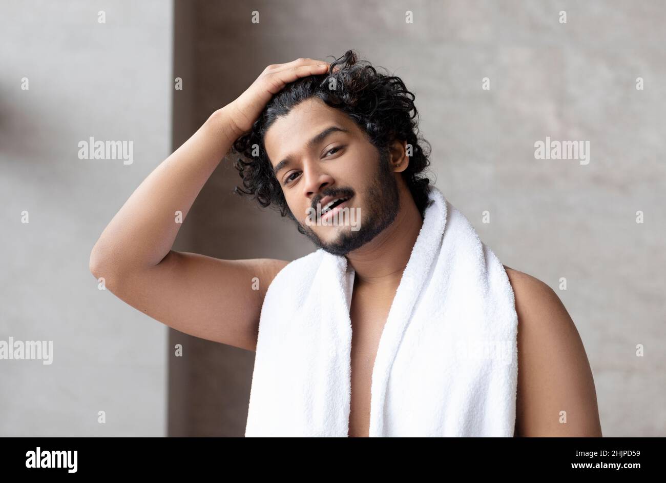Male morning routine. Handsome indian man with towel on shoulder ...