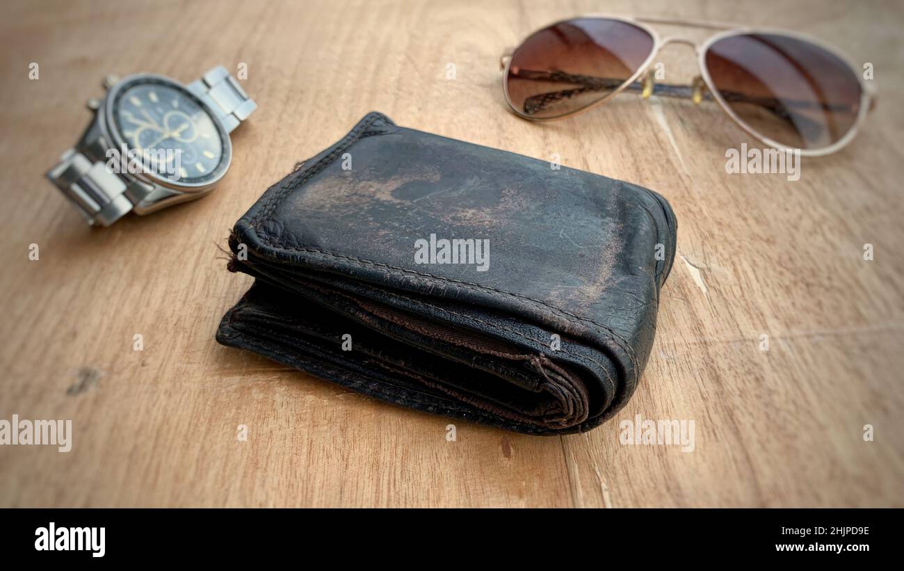 Old leather wallet on top of brown table Stock Photo - Alamy