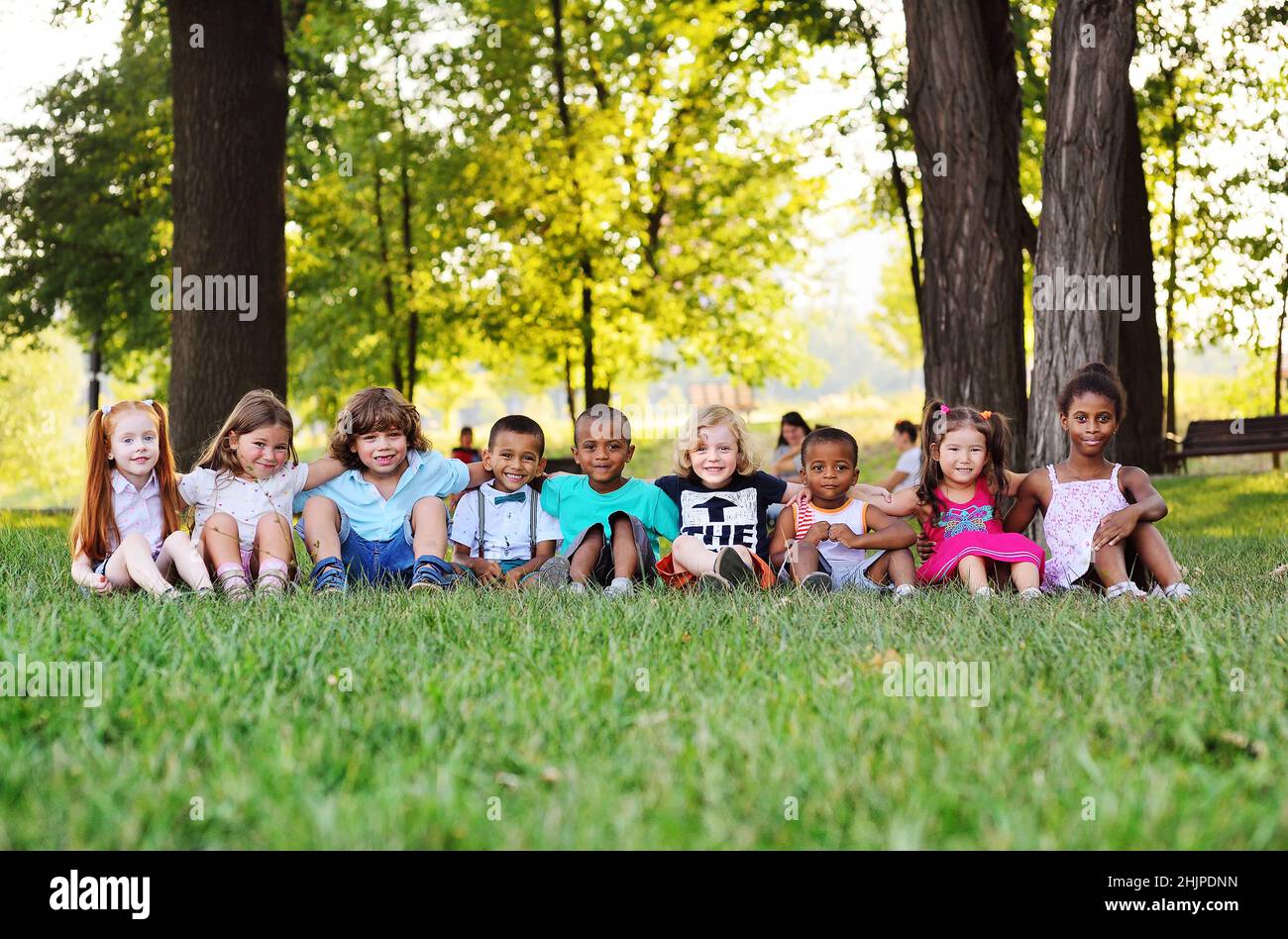 many young children of different races play together in the Park on the ...